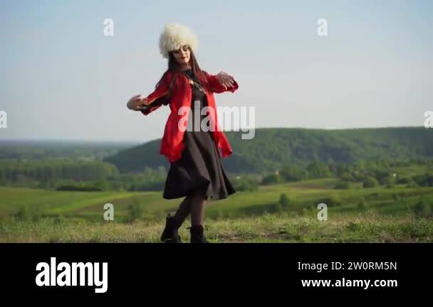 Georgian girl in white papakha and red national dress dances national ...