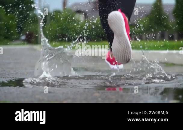 Legs of a runner in sneakers. Sports woman jogging outdoors, stepping ...