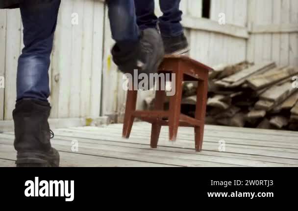 Executioner sentence man closeup 4K knock out chair with kick under ...