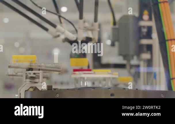 Arm taking items on conveyor under scanner of automatic test set, two ...