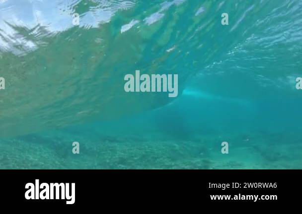 SLOW MOTION, UNDERWATER: Empty barrel wave rolling over the beautiful ...