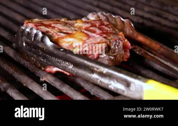 Preparation of steak on the grate and coals. Chef making steak. Beef ...