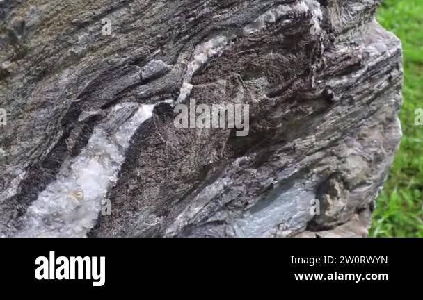 Folded layers of calc-silicate rock from a mountain, Thailand on ground ...