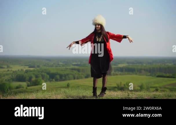 Georgian girl in white papakha and red national dress dances national ...