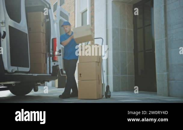 Delivery Man Uses Hand Truck Trolley Full of Cardboard Boxes and ...