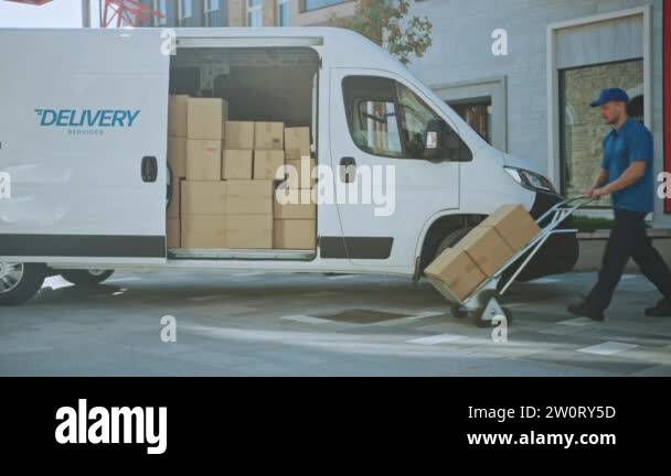 Delivery Man Uses Hand Truck Trolley Full of Cardboard Boxes and ...