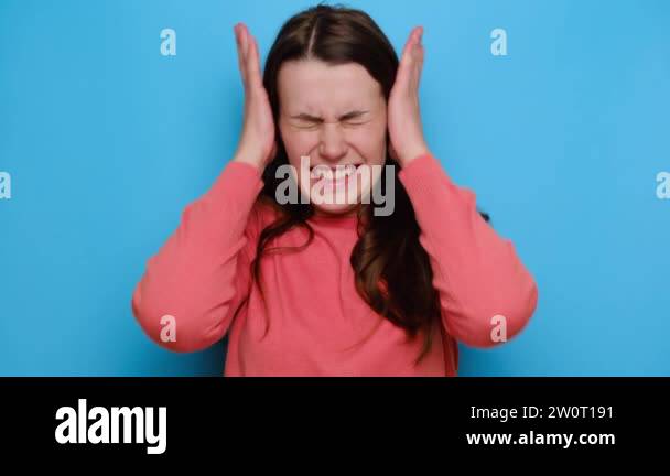 Portrait of sad disappointed young woman grabbing her head and ...