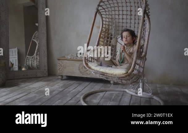 Adorable little muslim kid in arabic clothes with rosary beads reading ...