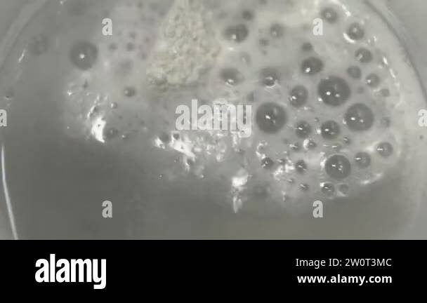Bubble foam in chemical flask. Chemical reaction with foam Stock Video ...