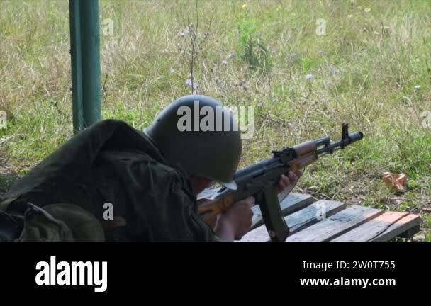 MOSCOW - JULY 30. Soldiers shoot from an AK-47 machine gun at targets ...