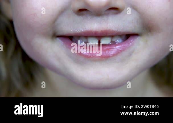 A little girl of two years shows her teeth. Close-up. 4k Stock Video ...