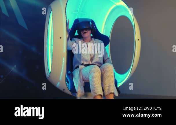 Emotional woman experiencing virtual reality in a moving interactive chair Stock Video Footage ...