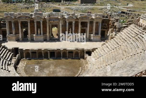 Ancient amphitheater with columns and a stage on which people performed ...