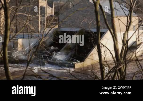 Flood Defence Turbine Energy Unit shown on a flooded UK river creating ...