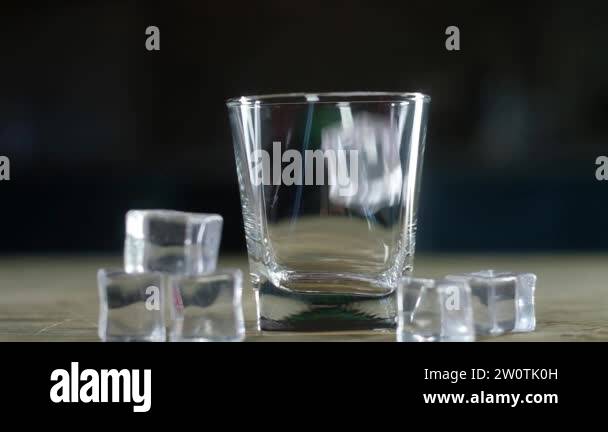 ice cubes fall into a clear, empty single malt glass. Bounce off the ...