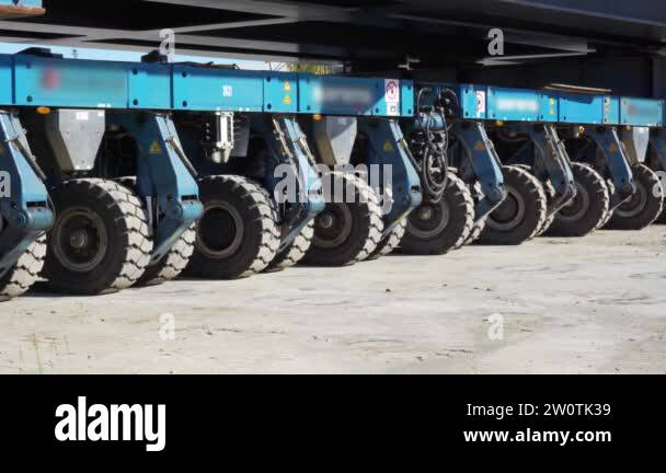 Heavy industrial self propelled modular trailer moving a train railway ...