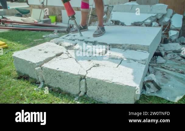 Man demolishing concrete wall with powerful jackhammer to smaller ...