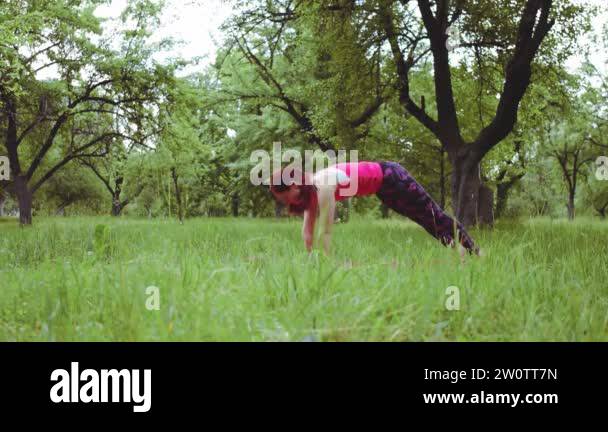 Yoga instructor girl showing extended side angle pose to downward ...