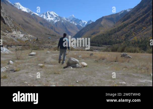 Rear View of Solo Indian traveler in winter clothing walking alone ...