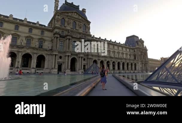 France. Circa August 2016. Tourists outside Louvre museum at sunset ...