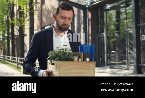 Angry man in 30s muttering and scolding his employer while walking and ...