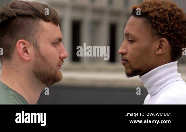 The black guy and the white man are staring at each other. Concept of ...