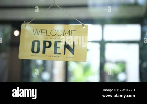 Coffee shop concept. A male employee is rolling over the coffee shop's ...