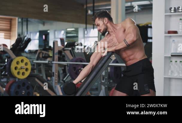 Handsome guy in a gym class bodybuilding concept lifting up the ...