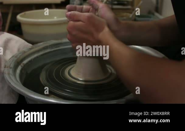 The master creates a white clay product. The master's hands close-up ...