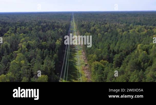 Tower of power lines in the forest. Electric tower line in Landscape ...