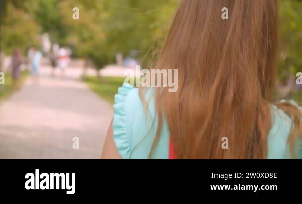 Closeup back view portrait of young long haired beautiful female ...