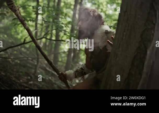 Portrait of Primeval Caveman Wearing Animal Skin and Fur Hunting with a ...