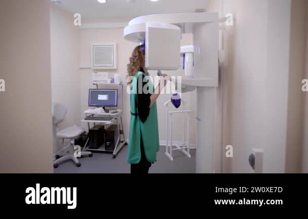 female patient of dental clinic is having x-rays of teeth in office ...