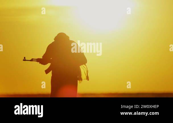 Islamic warrior with Kalashnikov at sunset day. Muslim fighter is ...
