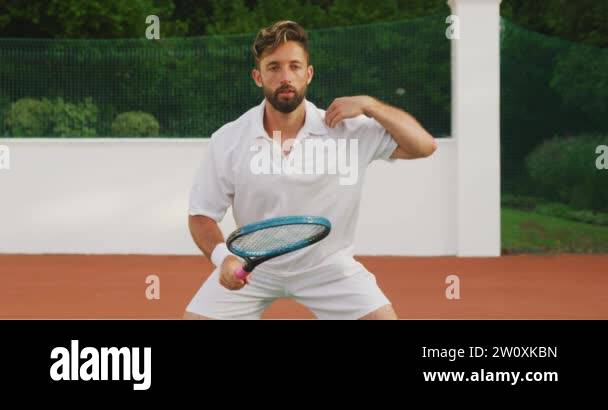 A mixed race man wearing tennis whites spending time on a court ...