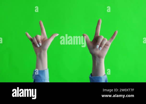 Sign of the horns with fingers on green screen. Simbol of heavy metal ...