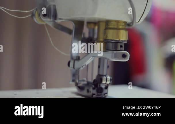 A professional sewing machine is in the workshop. Against the ...