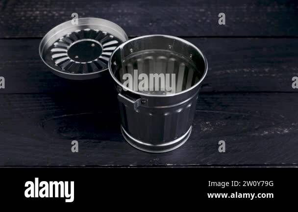 hand placing recycle symbol inside opened garbage bin metaphor of eco ...