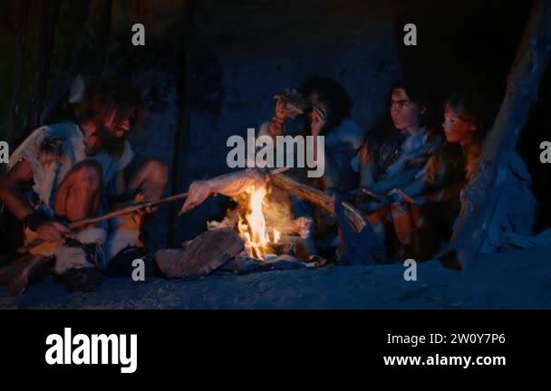 Neanderthal or Homo Sapiens Family Cooking Animal Meat over Bonfire and ...