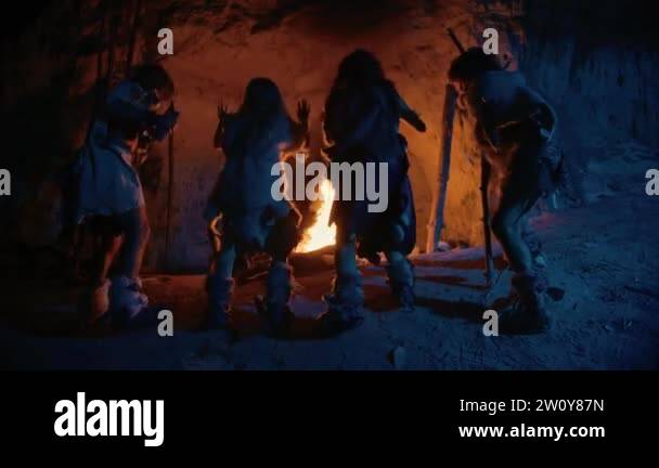 Tribe of Prehistoric Hunter-Gatherers Wearing Animal Skins Dance Around ...