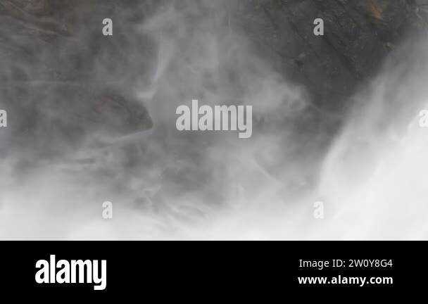 Slow motion of detail of waterfall, crop of fall and water vapor ...