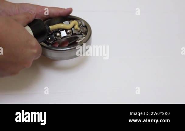 Applying grease to a spherical bearing by hand Stock Video Footage - Alamy