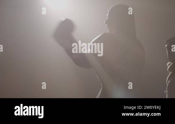 Muslim woman boxing shadow in haze lense flare. Side view silhouette ...