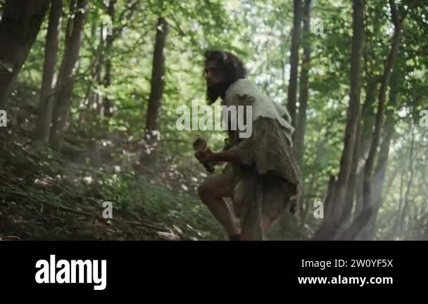 Portrait of Primeval Caveman Wearing Animal Skin and Fur Hunting with a ...
