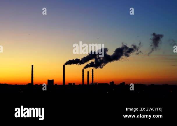 smoke from the factory chimneys at sunset. Chimneys of Power Plant at ...