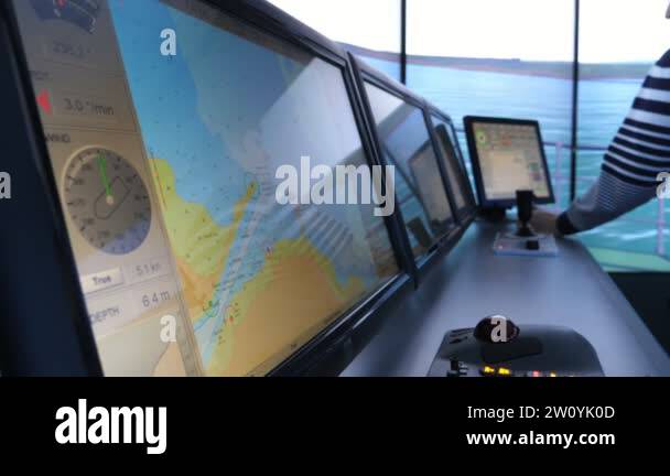 Four ship control screens with grids and maps on it on a moving vessel ...