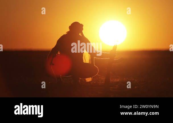 Islamic warrior with Kalashnikov at sunset day. Muslim fighter is ...