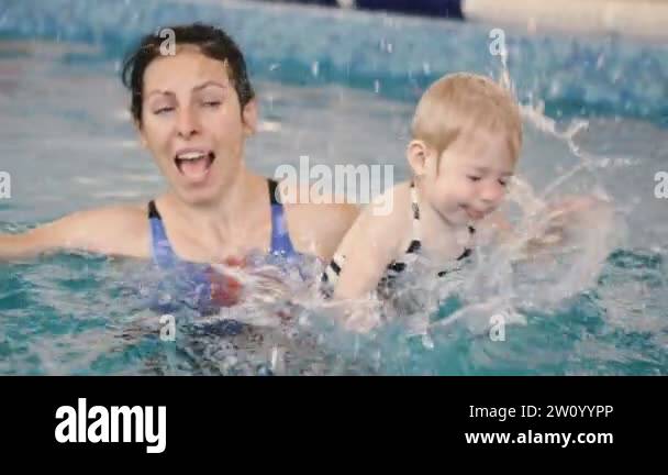 Swimming pool. Mom teaches a young child to swim in the pool Stock ...