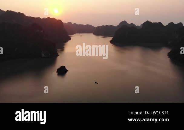 Aerial: unique flying over Ha Long Bay and Cat Ba island at sunset ...