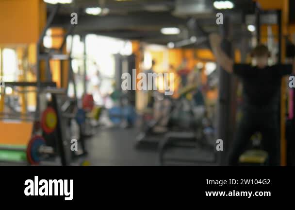 blurred background, general plan of the gym. athletes do traction of ...